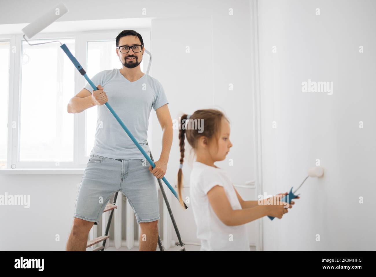 Young family of attractive father and cute little daughter having fun ...