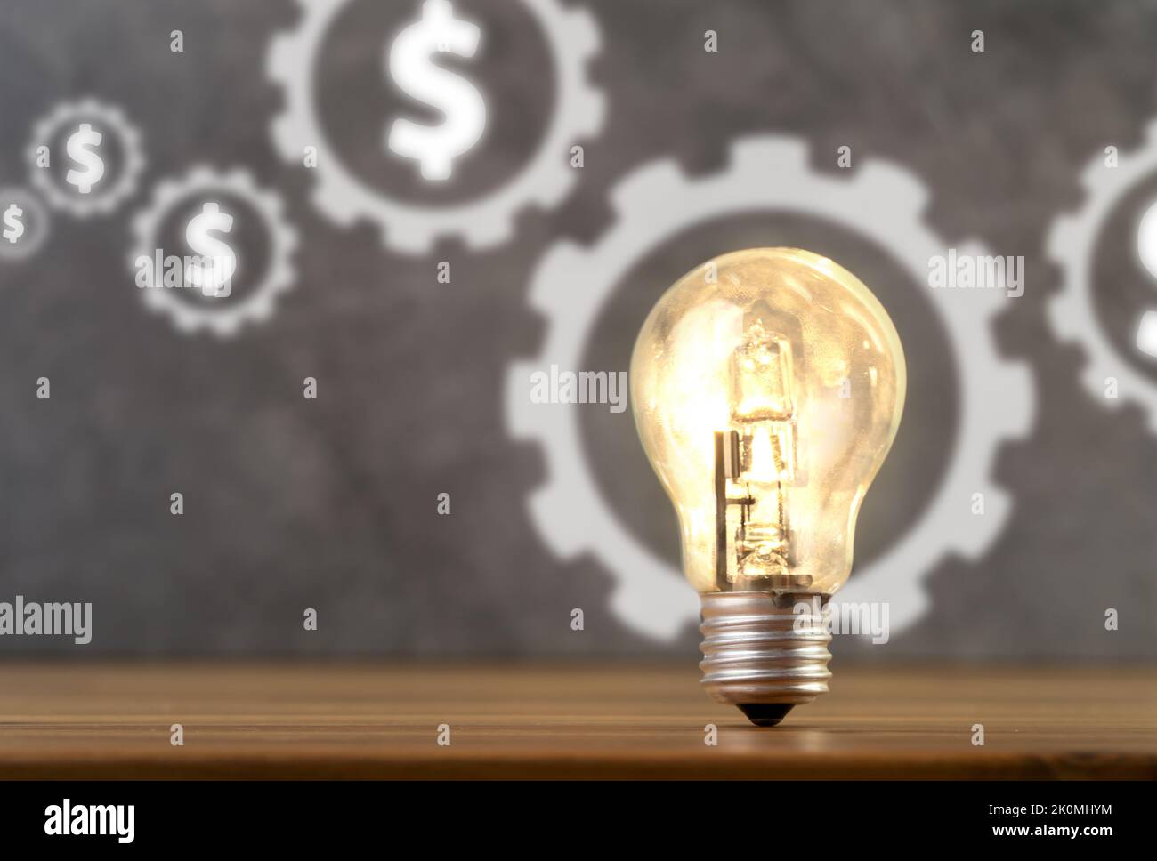 Close up photo of dollar sign and shining light bulb in one frame as a ...