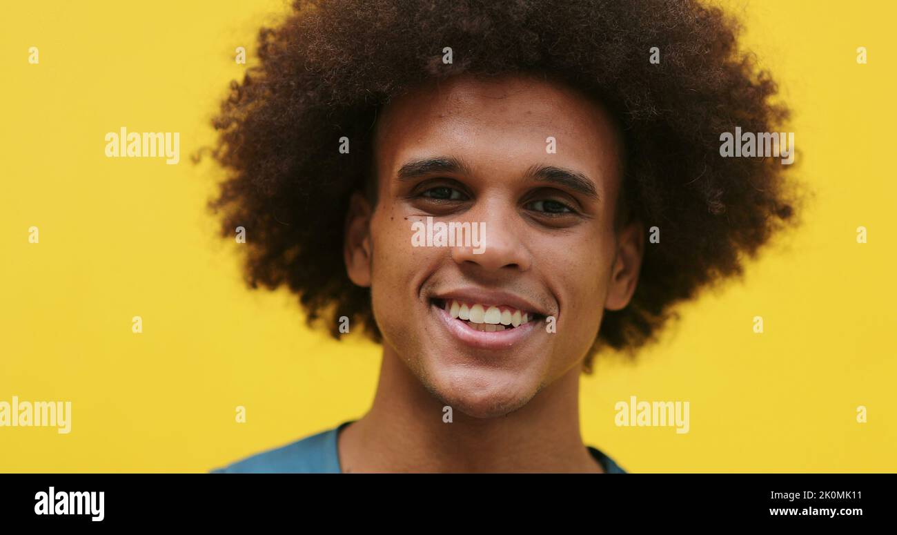 Smiley black african man with afro and yellow background Stock Photo ...