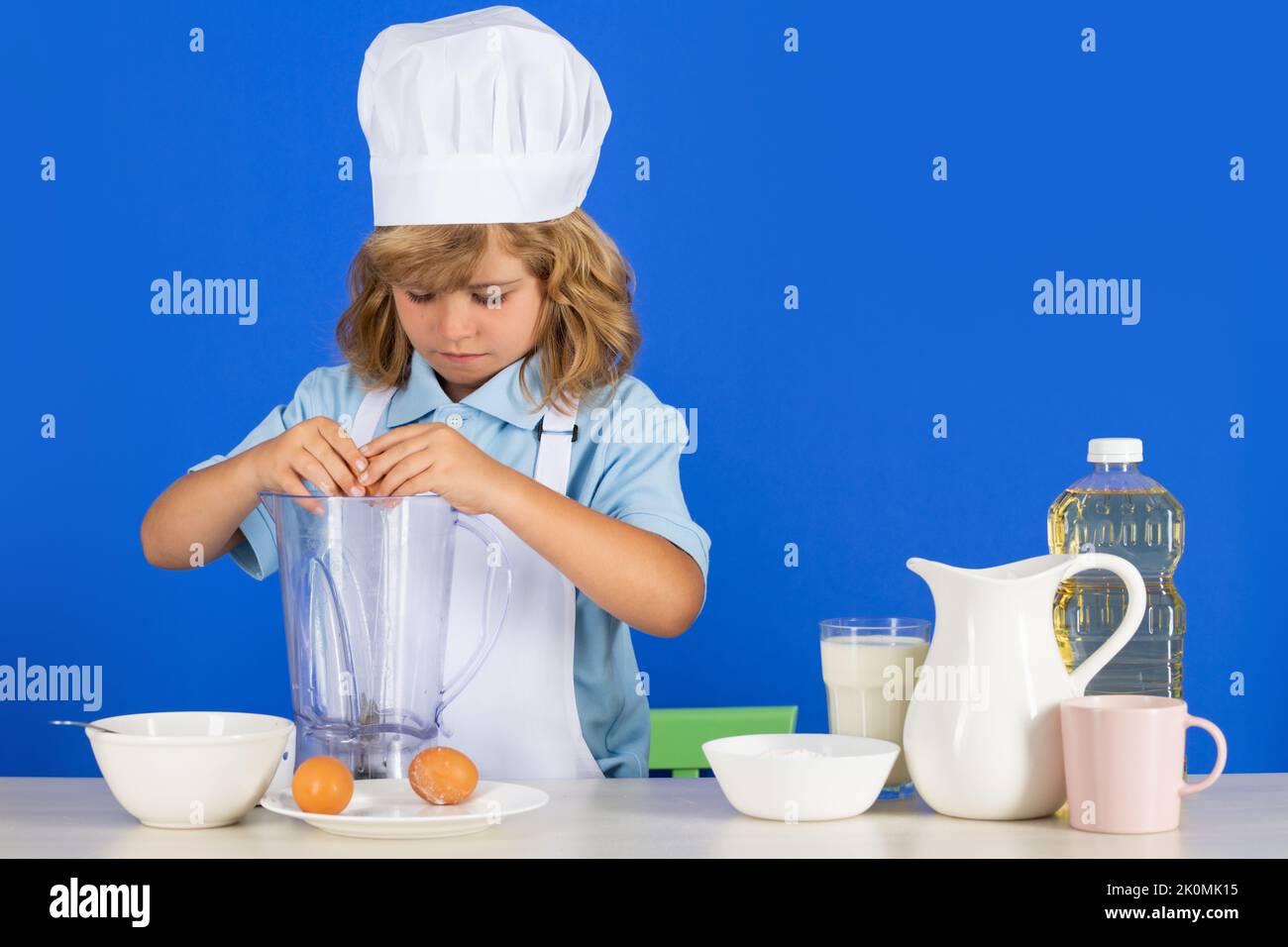 Cooking children. Chef kid boy making fresh vegetables for healthy eat ...