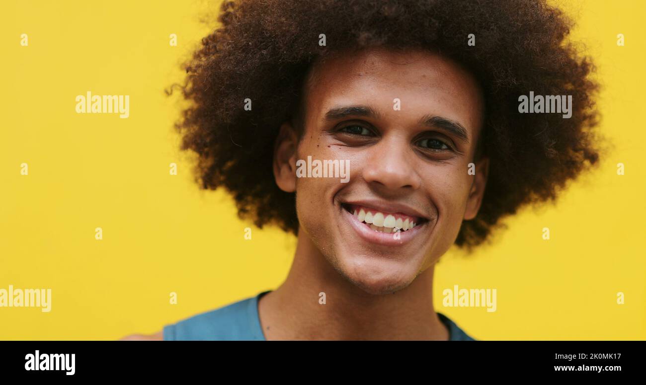 Smiley black african man with afro and yellow background Stock Photo ...