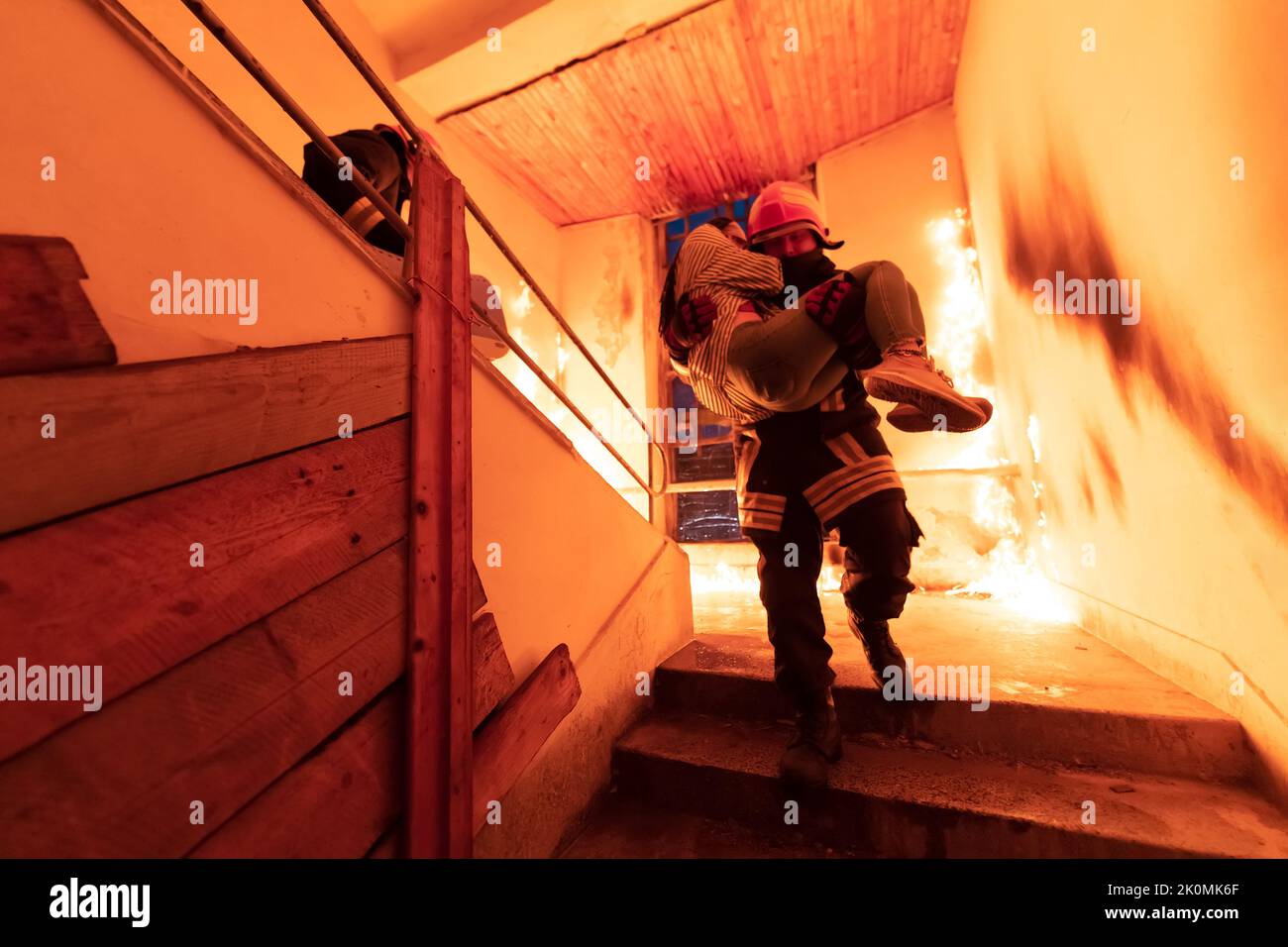 Brave Fireman Descends Stairs of a Burning Building and Holds Saved ...