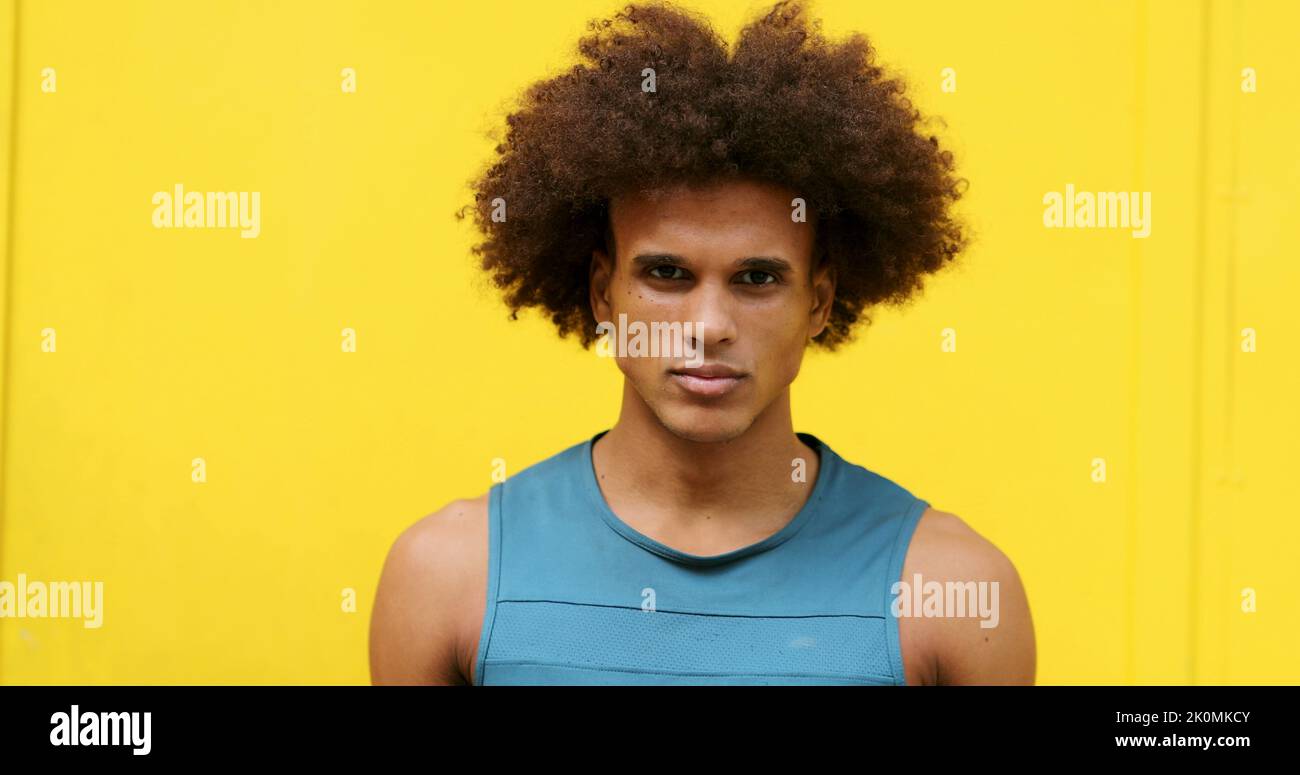 Young african american mixed rac man changing emotion in yellow ...