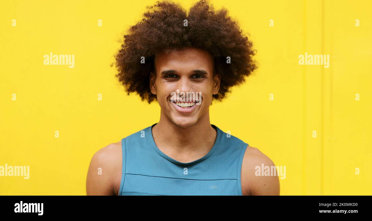 Young african american mixed rac man changing emotion in yellow ...