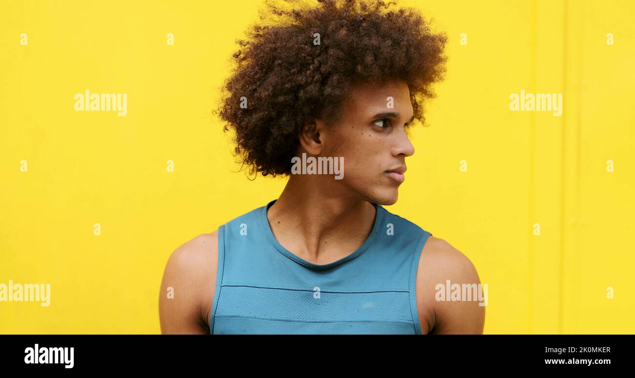 Young african american mixed rac man changing emotion in yellow ...