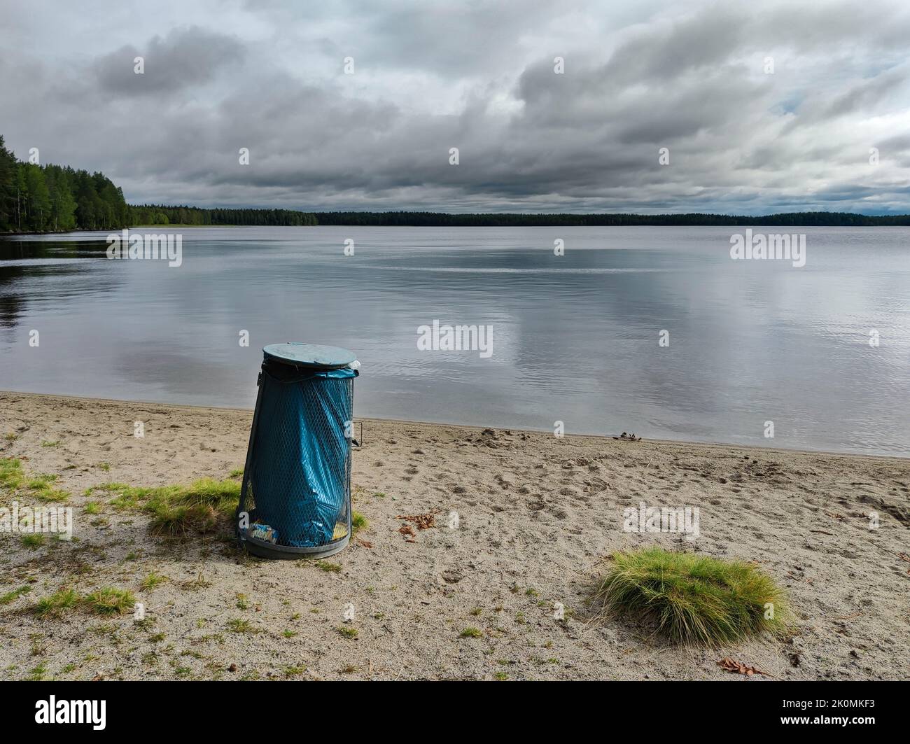A rubbish bin near a lake Stock Photo - Alamy