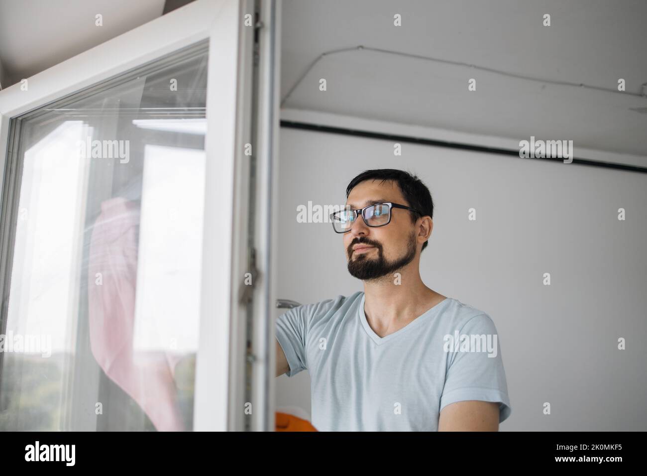 Close up portrait of bearded caucasian man in eyeglasses, sitting on ...