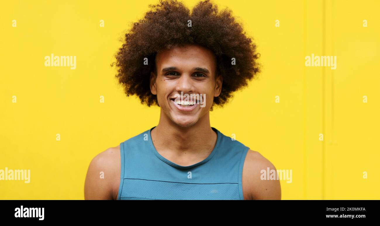 Young african american mixed rac man changing emotion in yellow ...