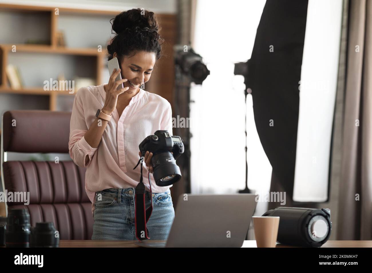 Beautiful creative woman photographer working, having phone ...