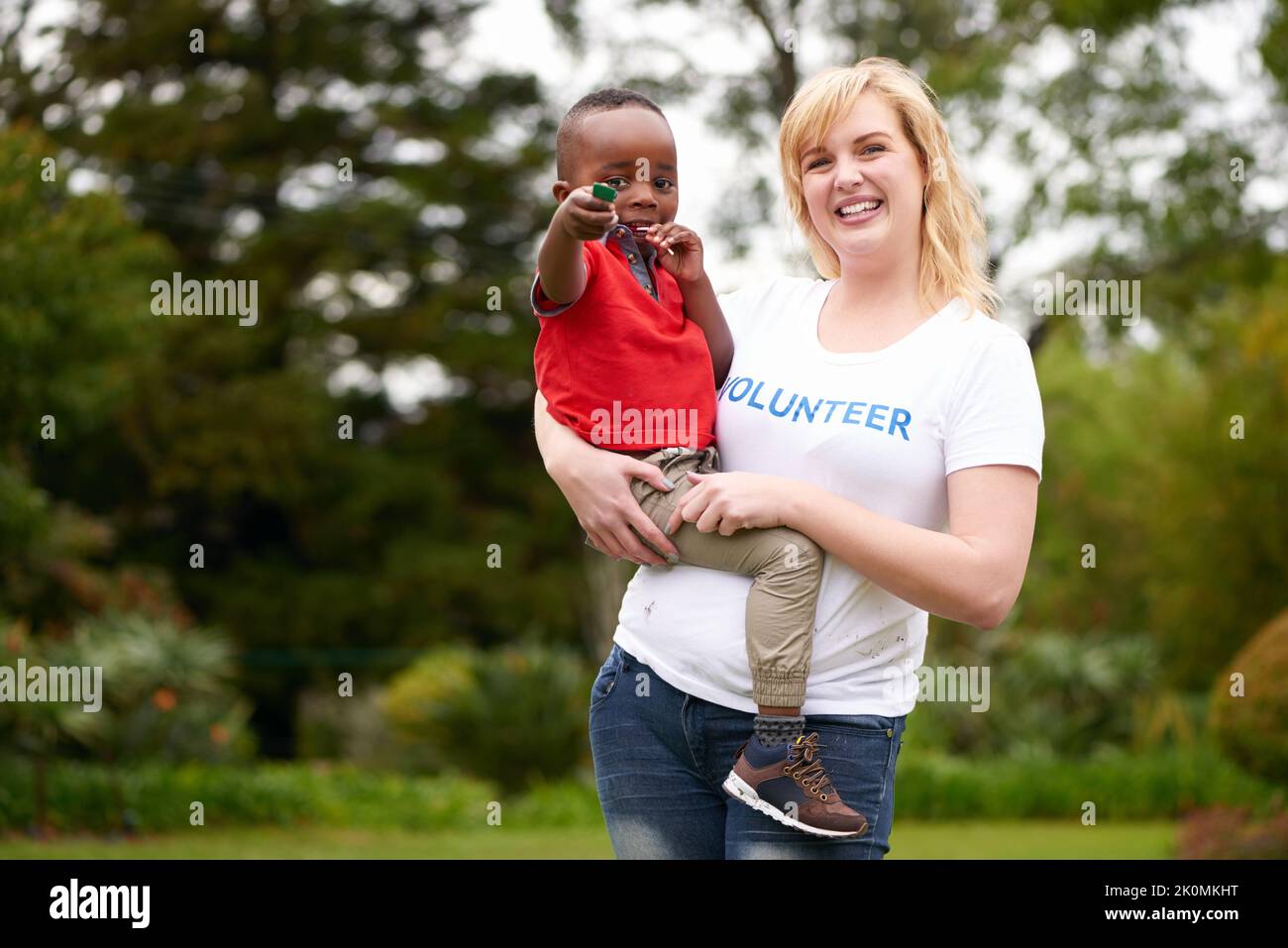 You can do something to help those in need. a female volunteer carrying ...