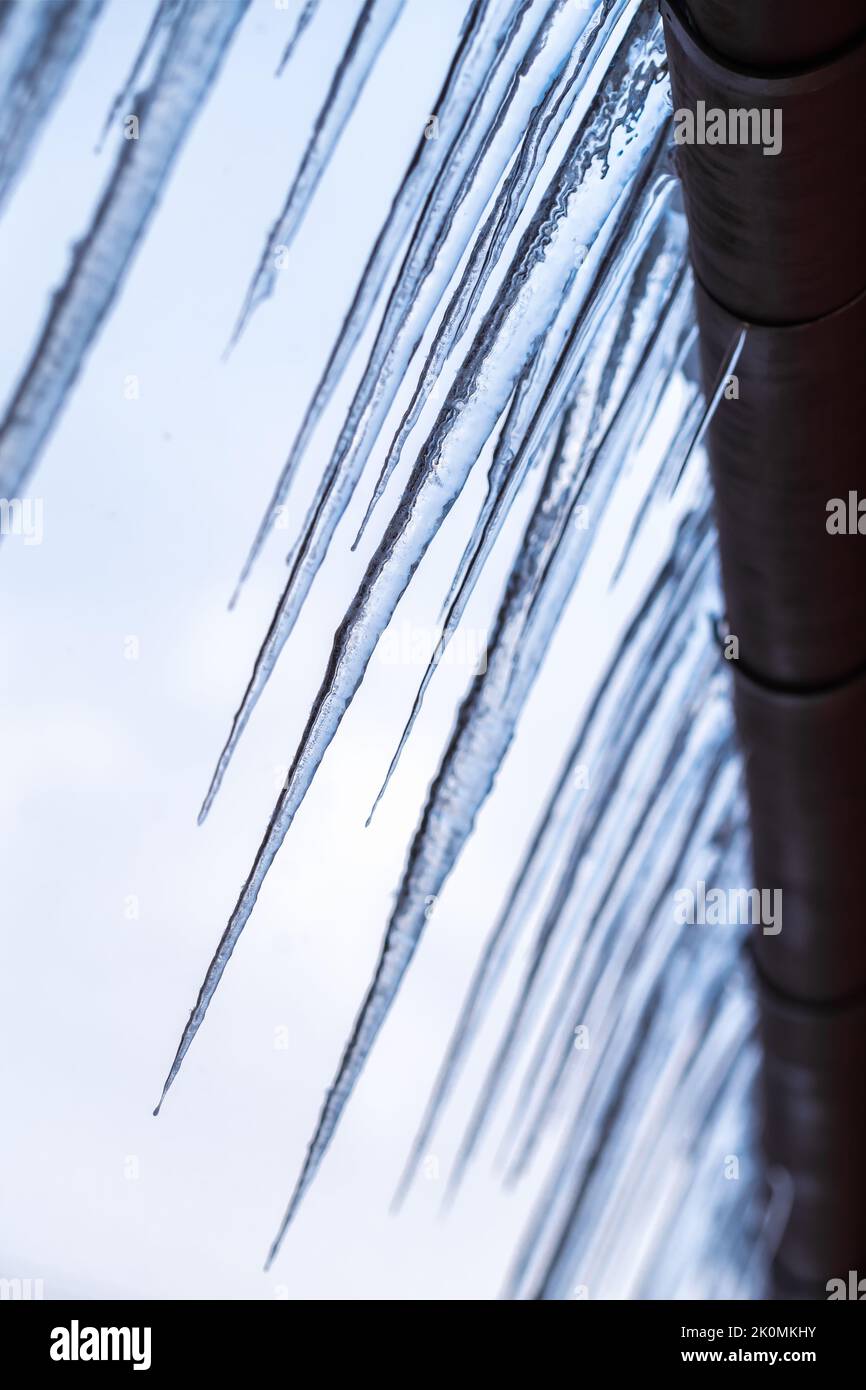 Long and dangerous icicles hanging from roof of house Stock Photo - Alamy