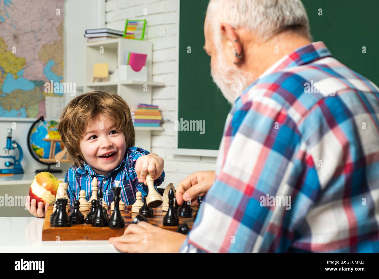 Grandfather son playing chess, happy men generations family. Old ...