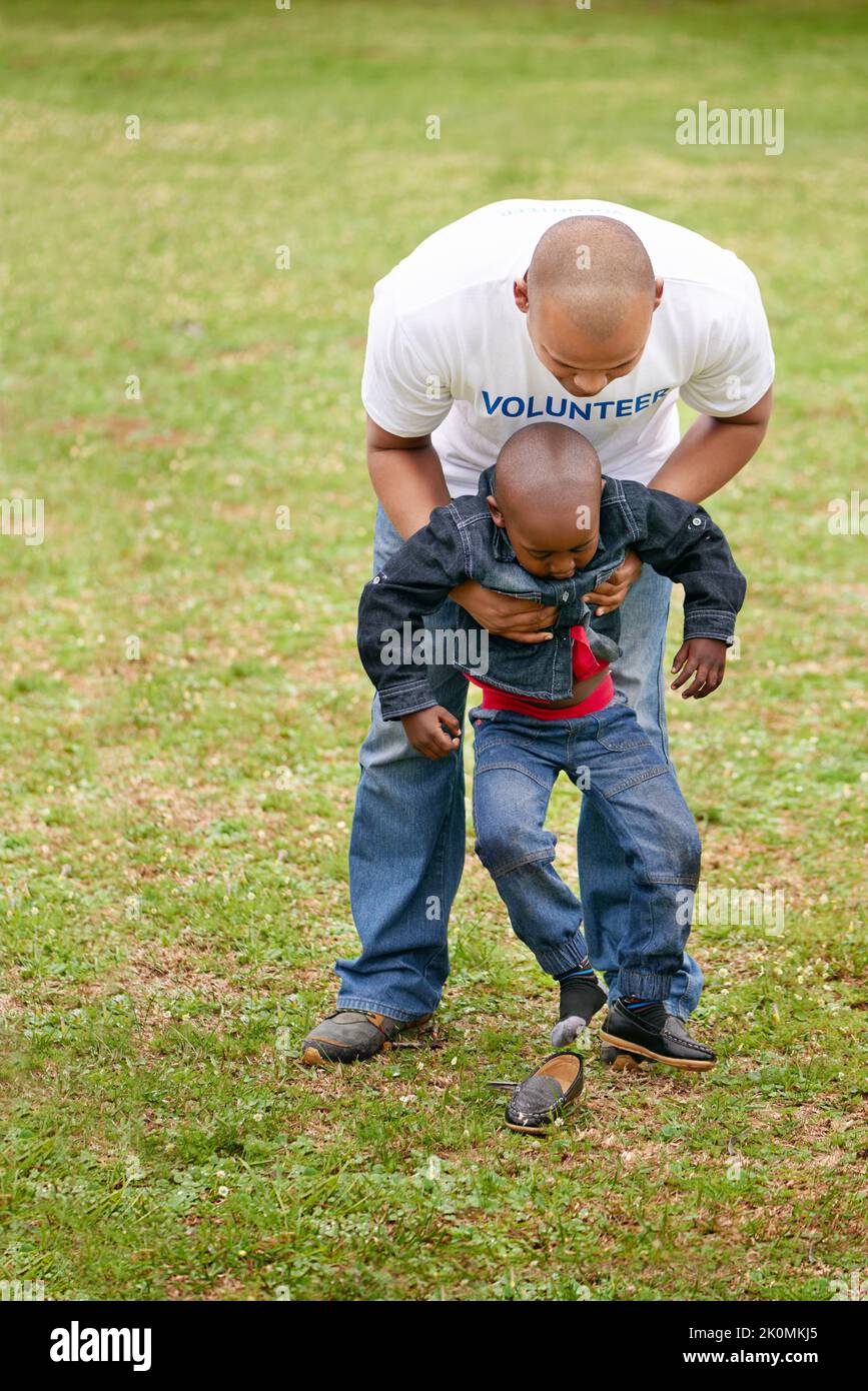 Boy helping charity hi-res stock photography and images - Alamy