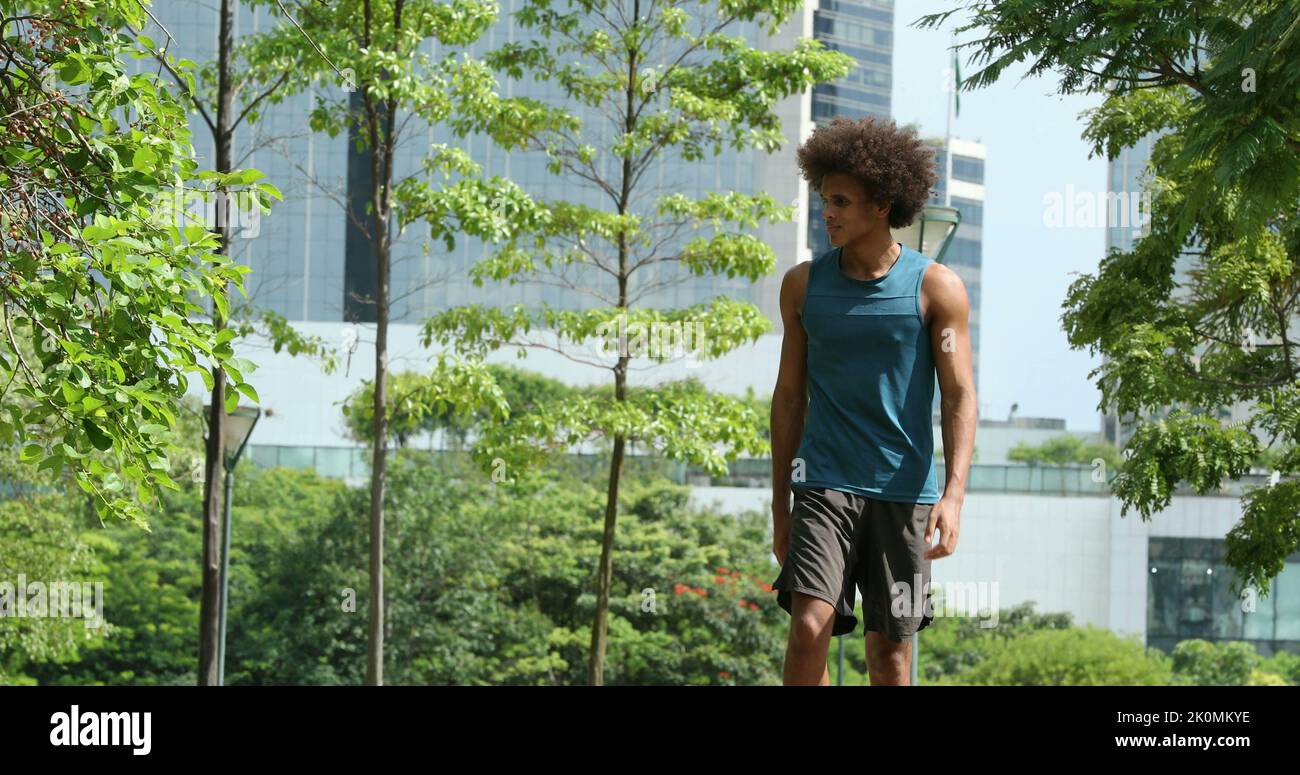 Sportive young black african man walking at park Stock Photo - Alamy