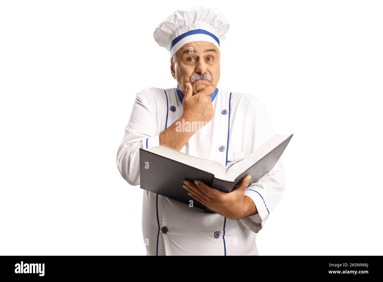 Confused male chef holding a cook book isolated on white background ...