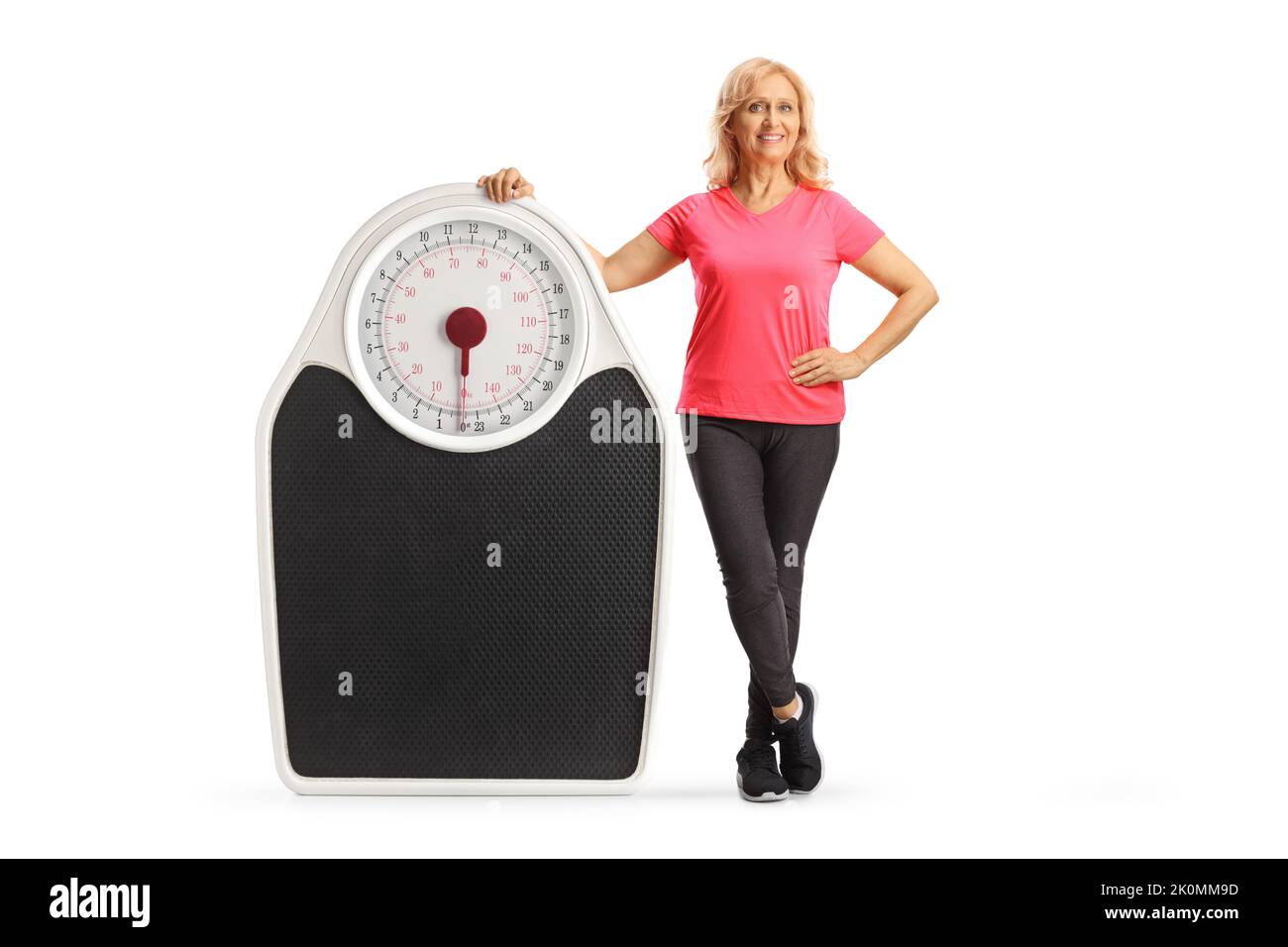 Full length portrait of a mature woman in sportswear posing next to a ...