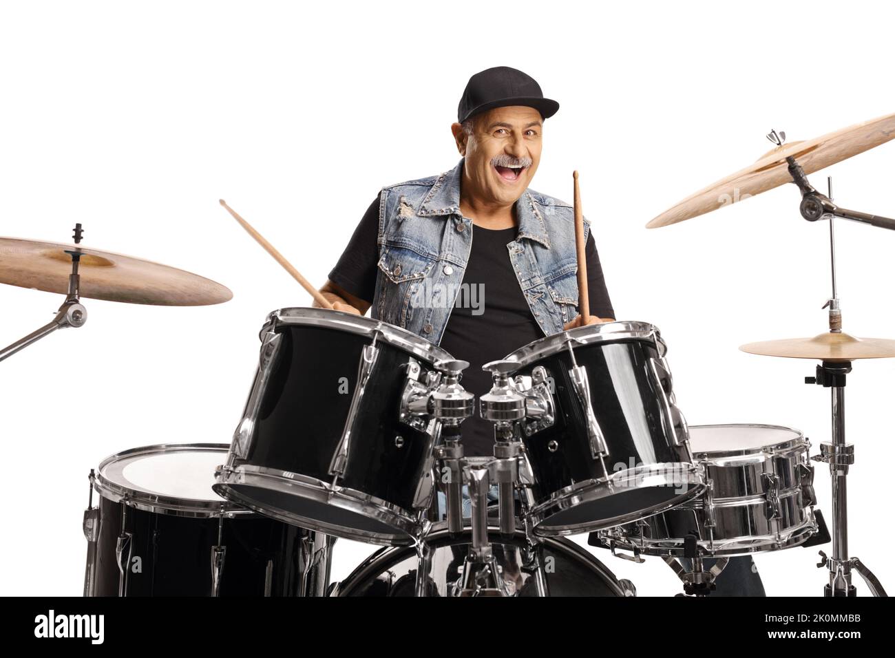 Cheerful mature drummer playing and smiling isolated on white ...