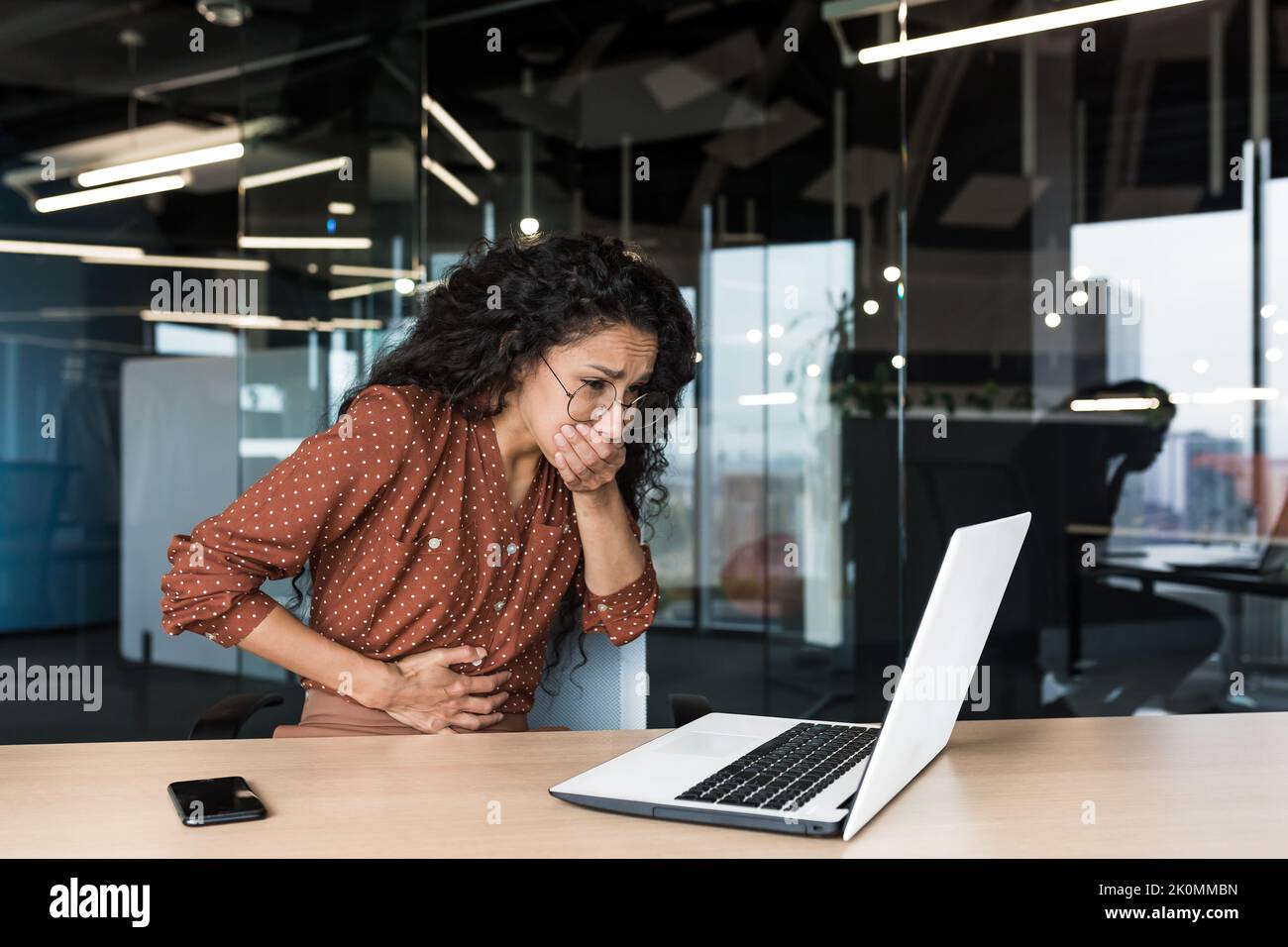 Sick business woman working at work, having severe nausea and abdominal ...
