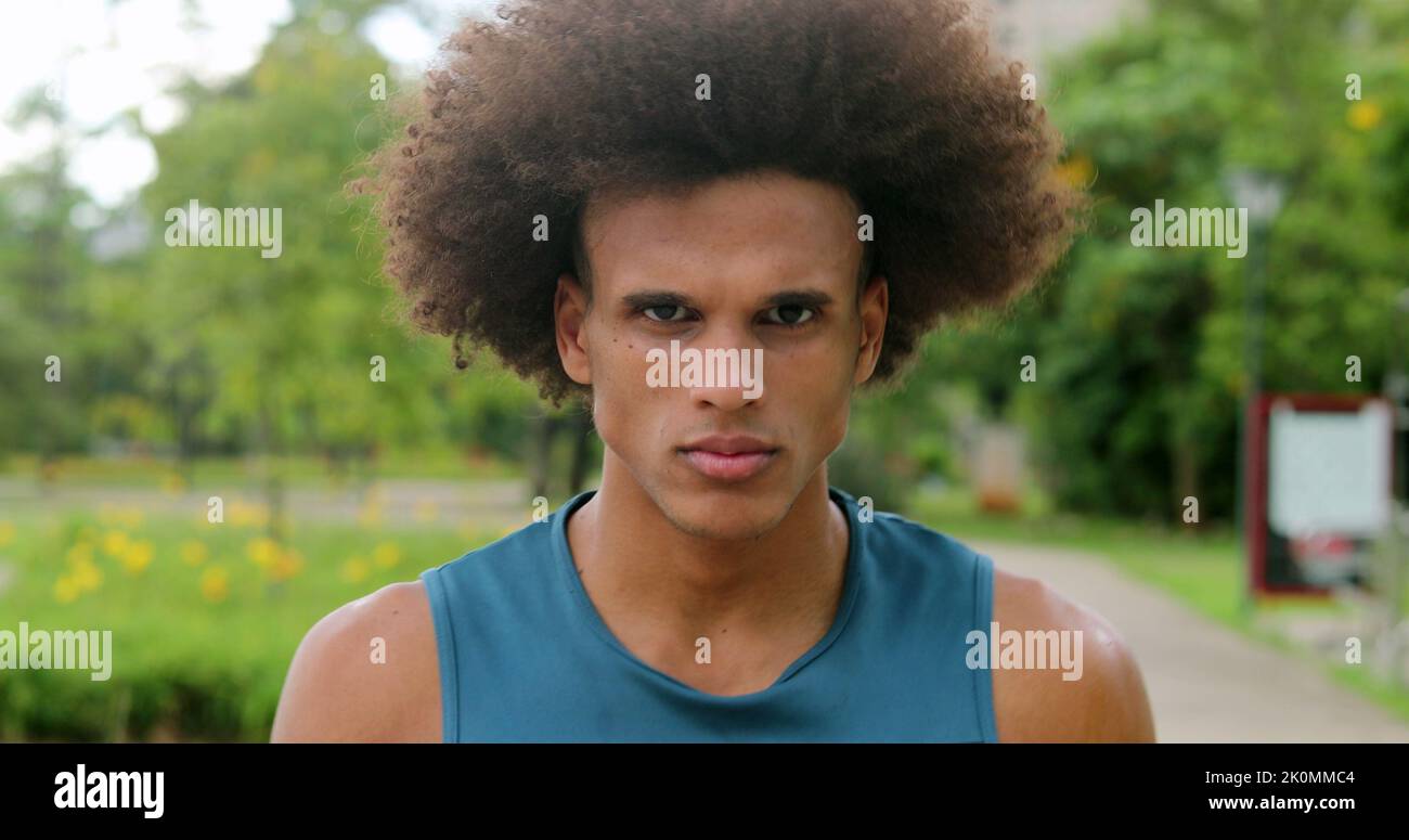 Portrait of serious african black man walking forward towards camera ...