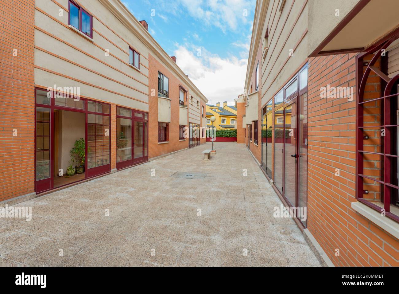 passageway between single-family urban residential homes with red ...