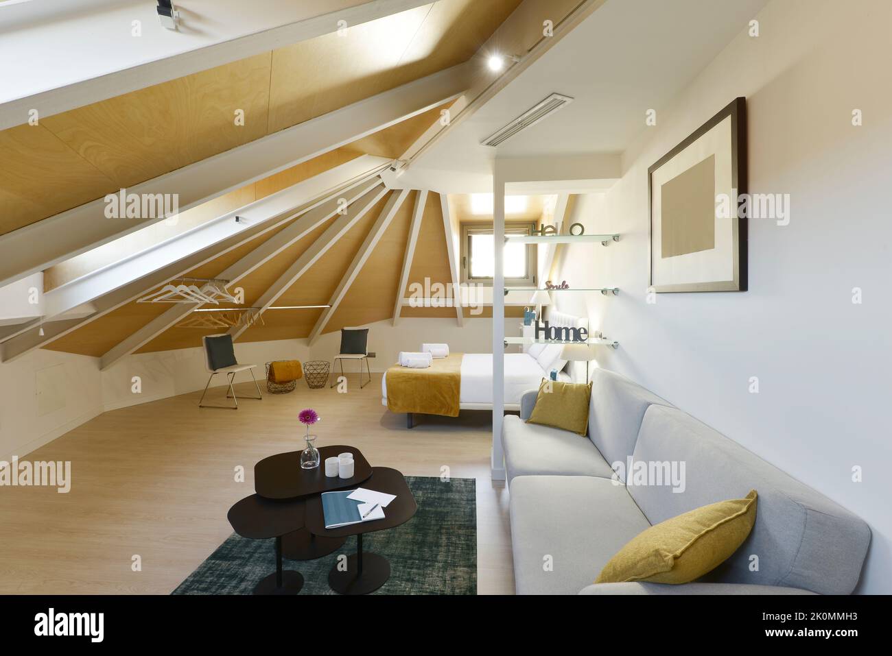 living room in a studio apartment with loveseats with gray fabric ...