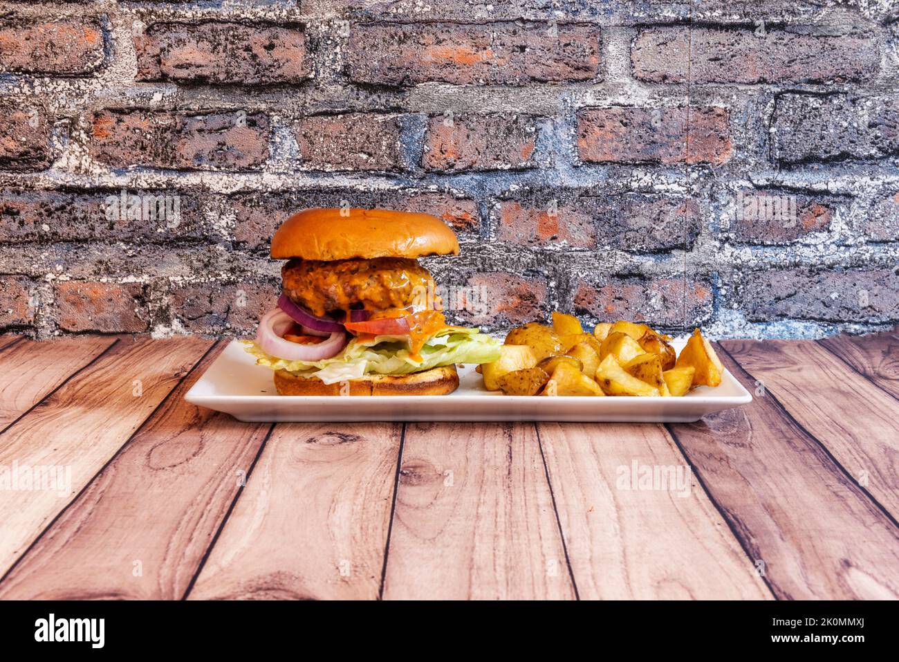 Delicious beef burger with a lot of curry sauce, a lot of lettuce, raw ...