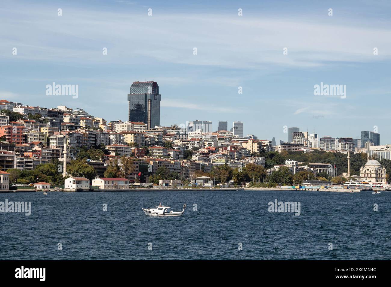 View of a small fishing boat on Bosphorus and Gunussuyu area of Beyoglu ...