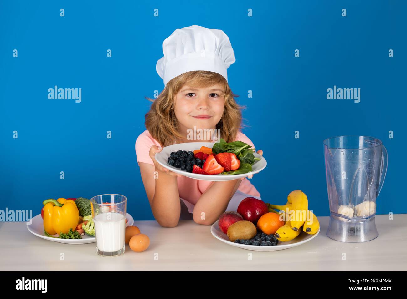 Cooking children. Chef kid boy hold plate with fruits making fresh ...