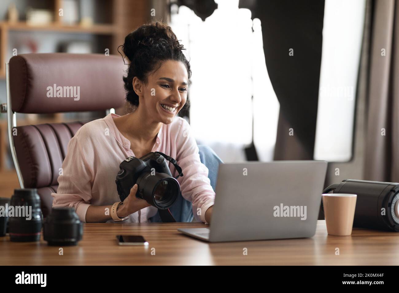 Creative millennial lady photographer enjoying her job Stock Photo - Alamy