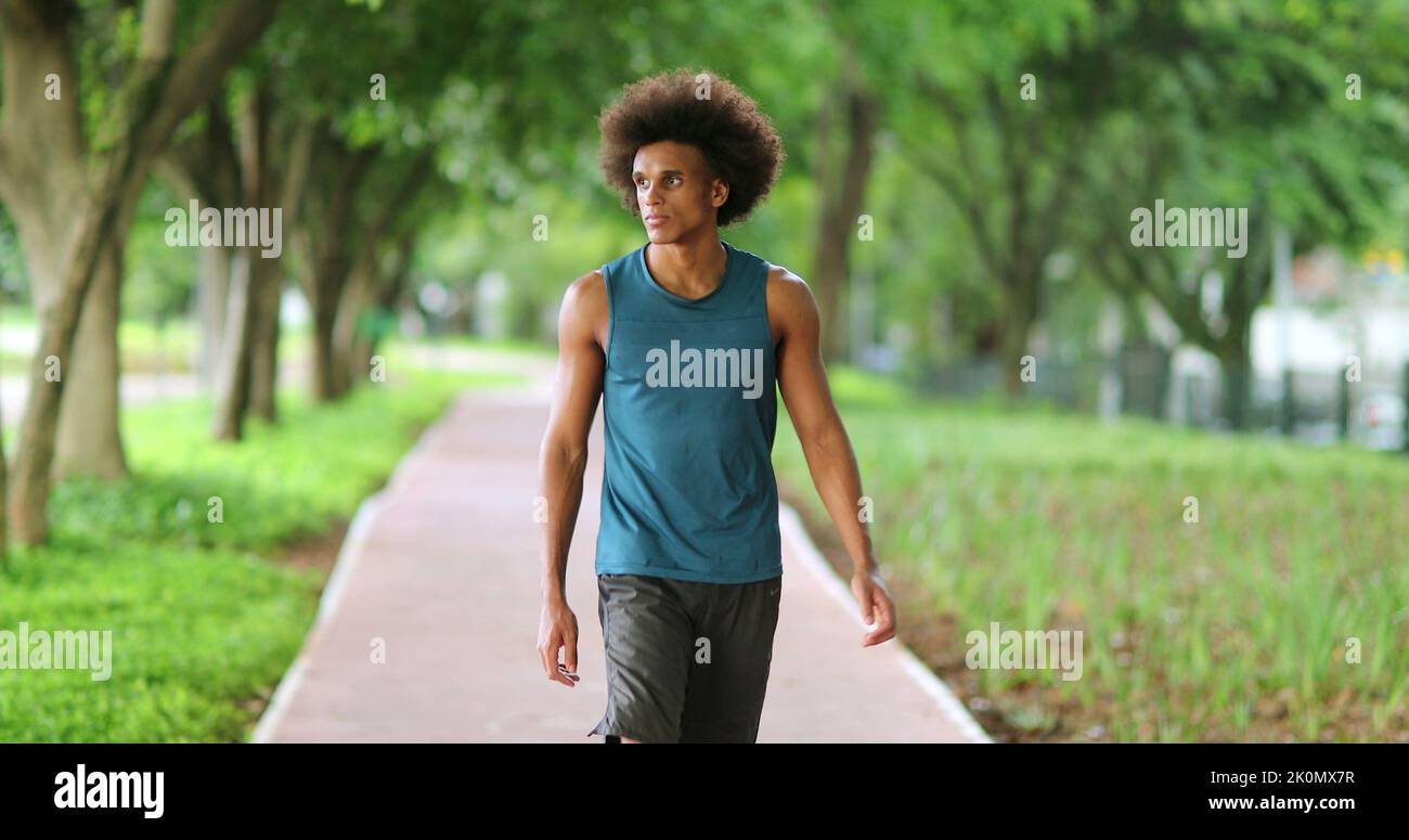 Young black handsome african man walking at park pathway Stock Photo ...