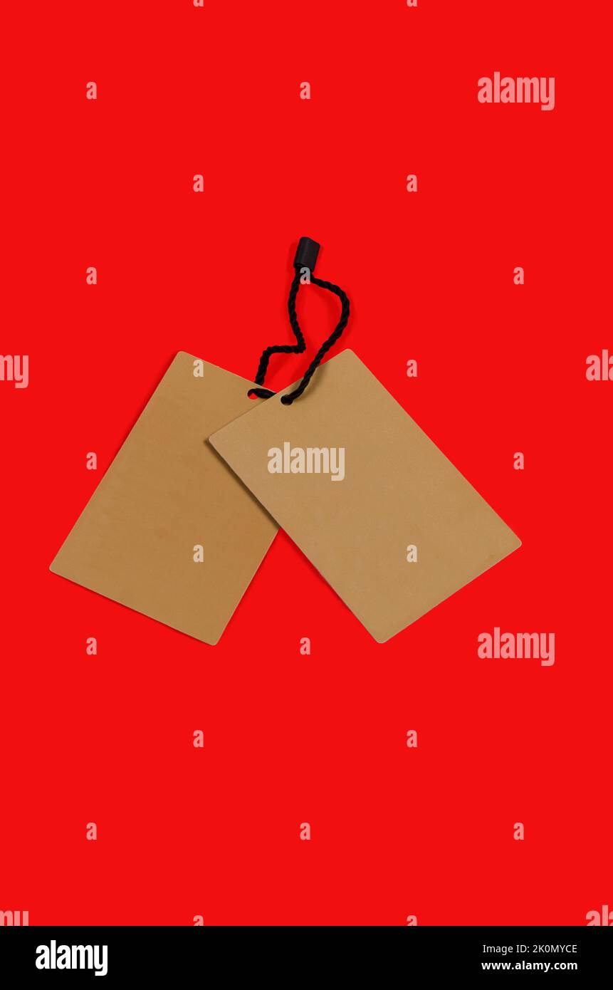 Empty brown cardboard tag with string on red background. Vintage paper ...
