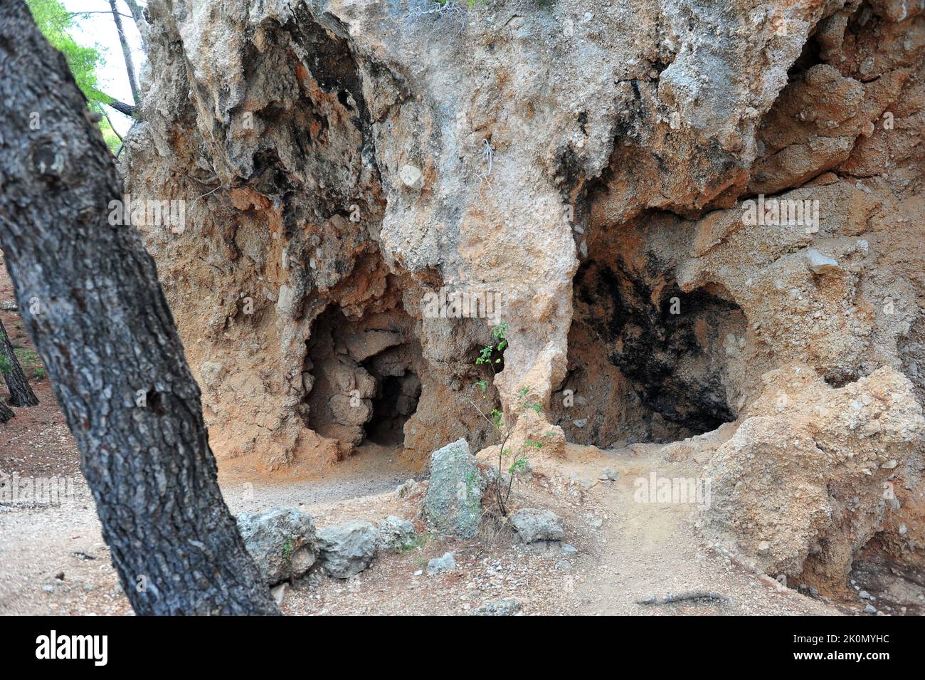 Small cave entrance in Vaska Boda, Croatia. Mounain wall along walking ...