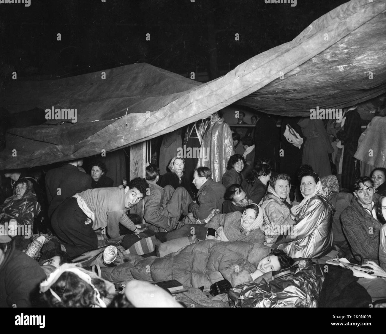 File photo dated 01/06/53 of people under a makeshift tent, formed by a ...