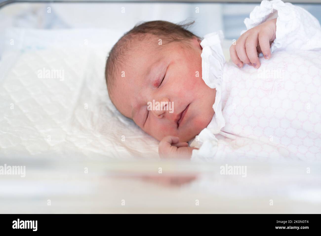 newborn. baby newborn a close-up lies with eyes closed in the hospital ...