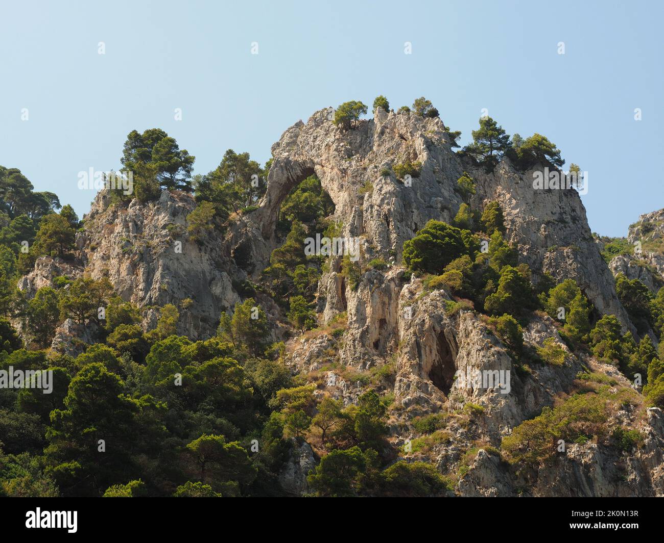Famous rock formation arco naturale on Capri island, seen from the sea ...