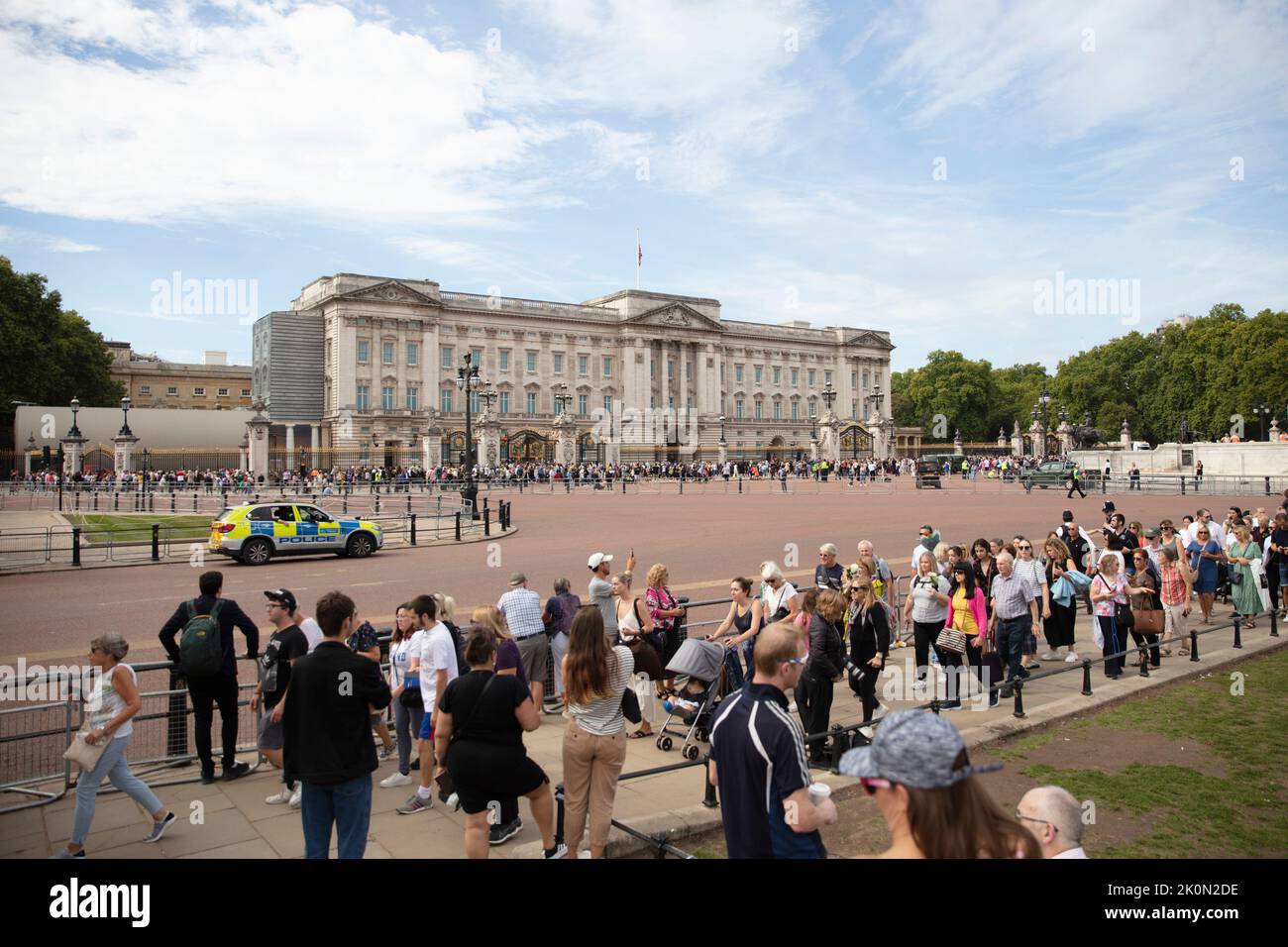 LONDON, UK - September 2022: People make their way to Buckingham Palace to pay tribute to Queen ...