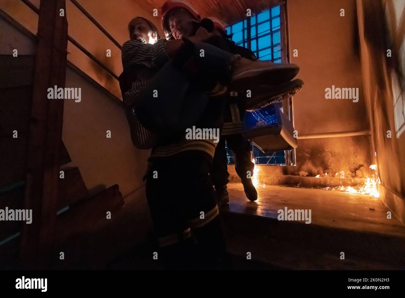 Brave Fireman Descends Stairs of a Burning Building and Holds Saved ...