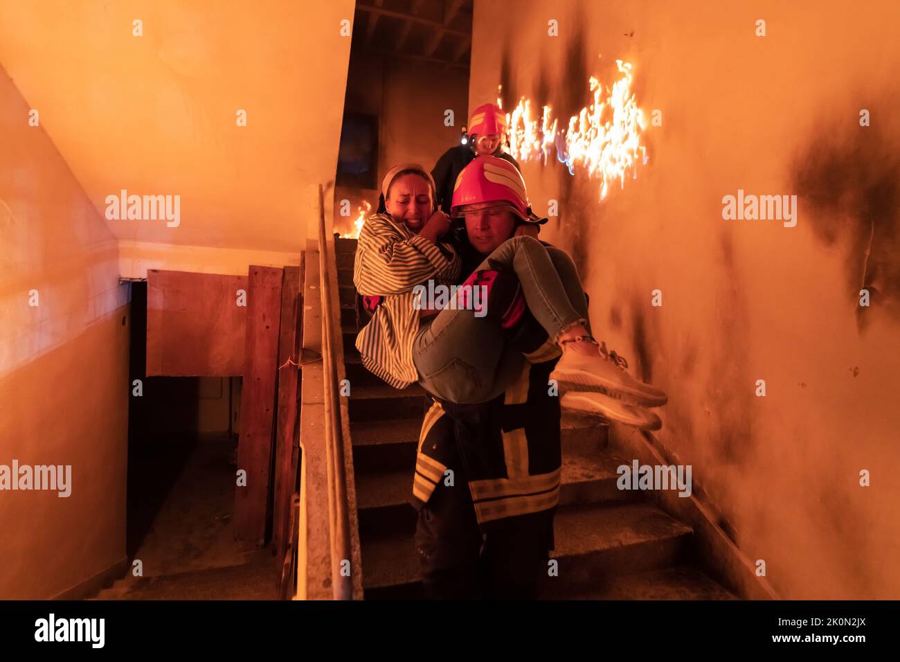 Brave Fireman Descends Stairs of a Burning Building and Holds Saved ...