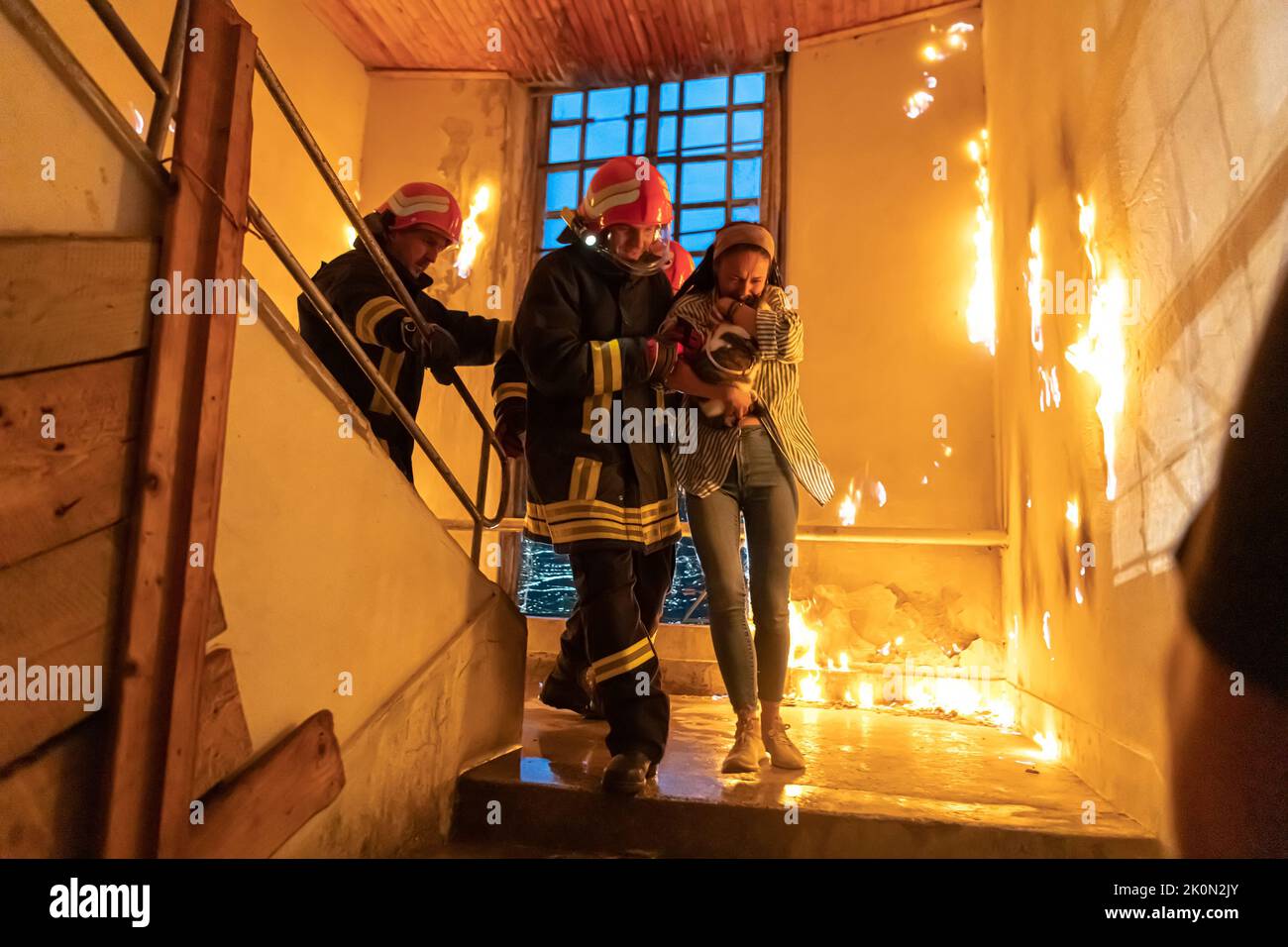 Brave Fireman Descends Stairs of a Burning Building and Holds Saved ...