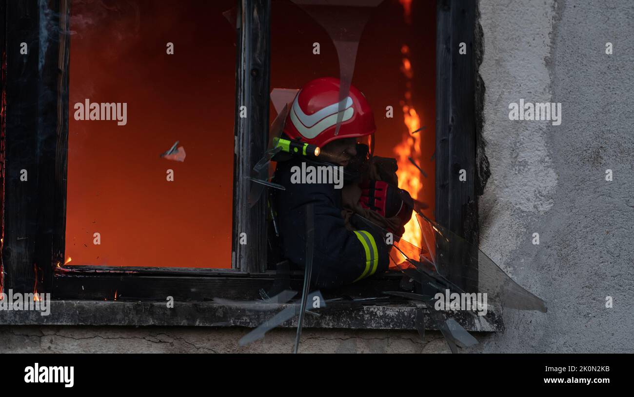 Firefighter hero carrying baby girl out from burning building area from ...