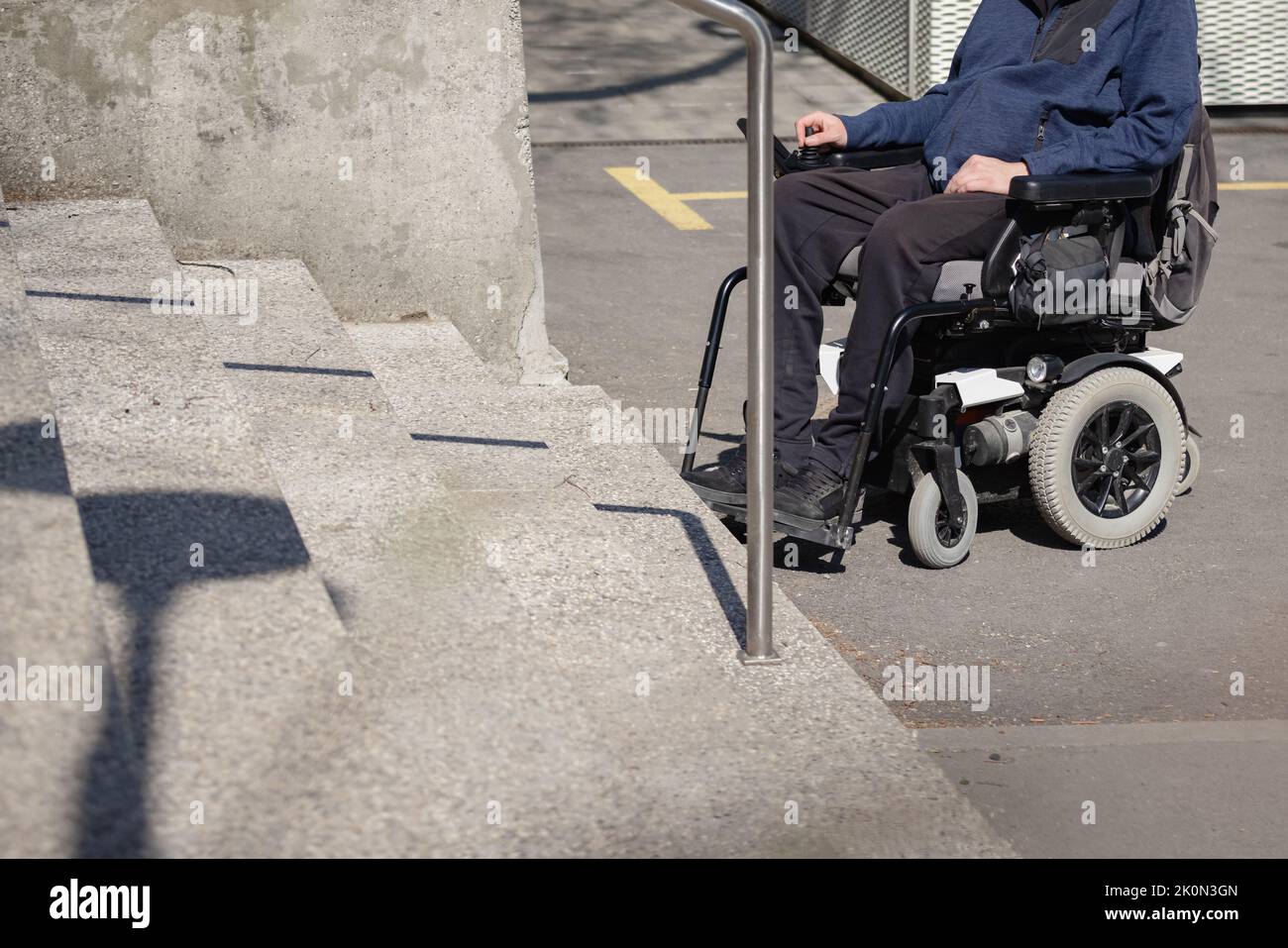 Person with disability on electric wheelchair stopping at the bottom of ...