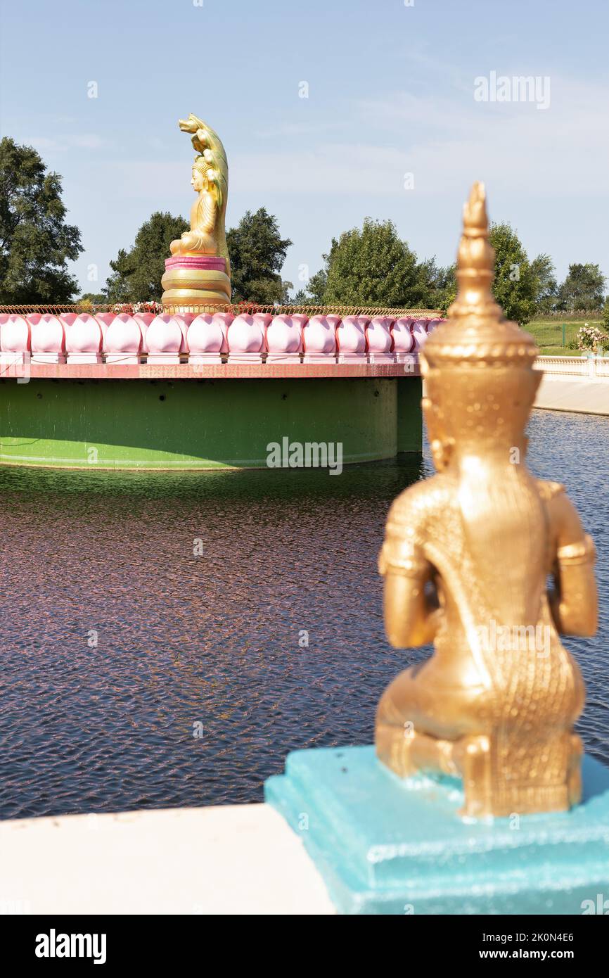 A gold Buddha with serpents statue at Watt Munisotaram Cambodian ...