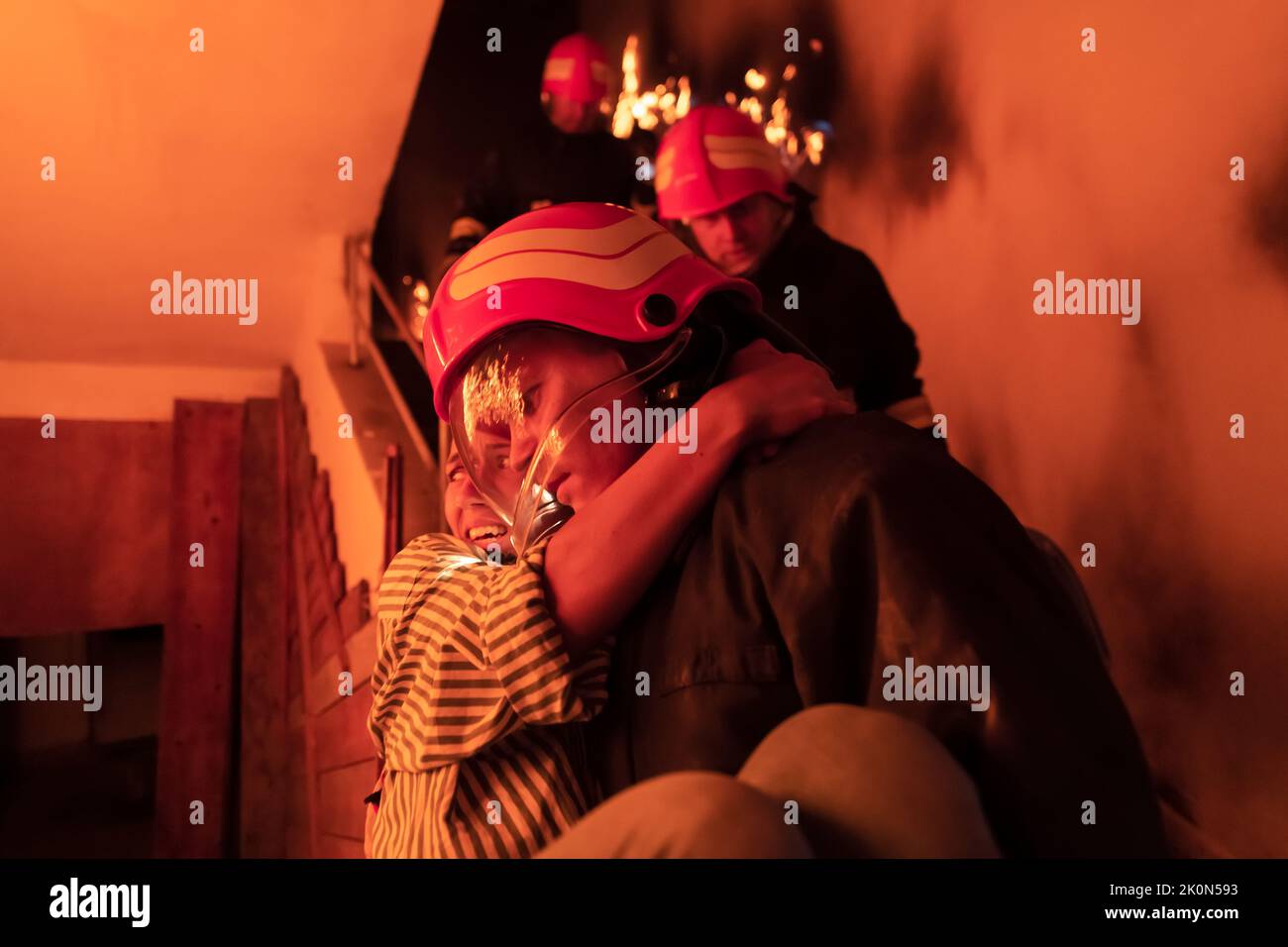 Brave Fireman Descends Stairs of a Burning Building and Holds Saved ...