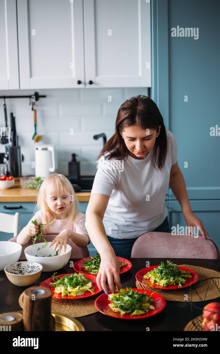Mom and daughter together prepare dinner for a large family in the ...