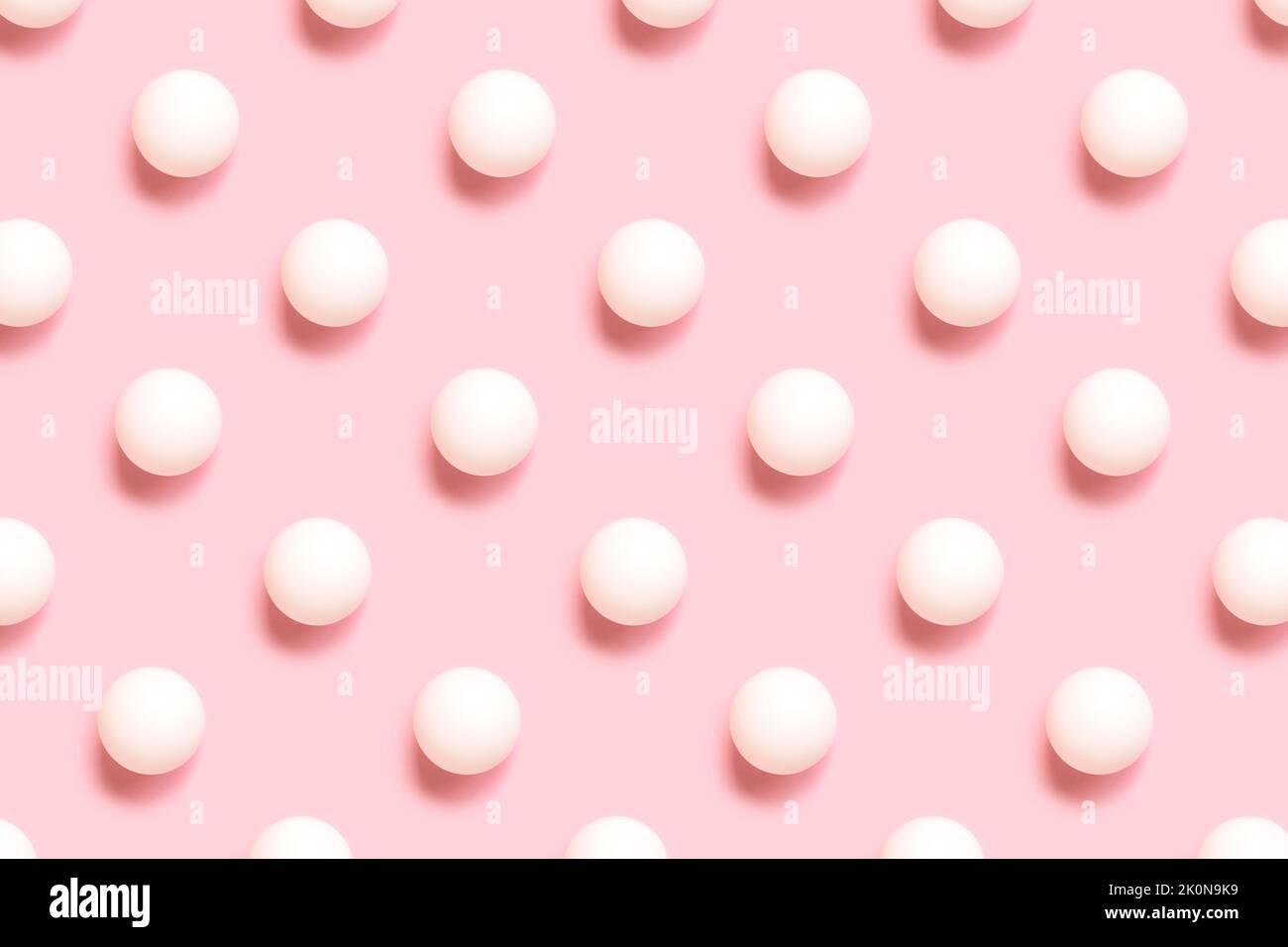 Repetitive pattern made white ping pong ball on a pink background ...