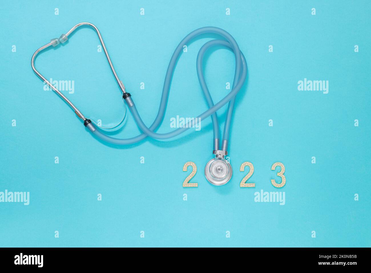 Medical stethoscope and the numbers new year 2023 on a blue background ...
