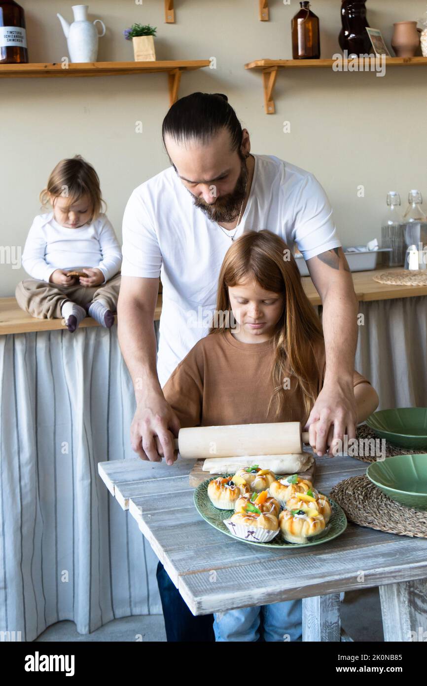 A family with three children has fun baking together.Dad And Daughter ...