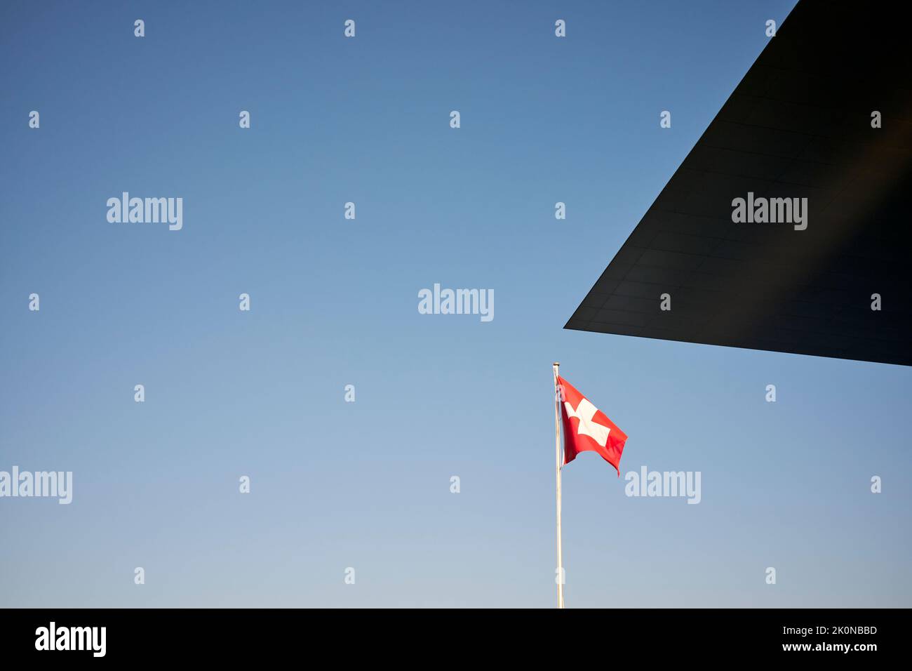 Swiss flag against blue sky Stock Photo - Alamy