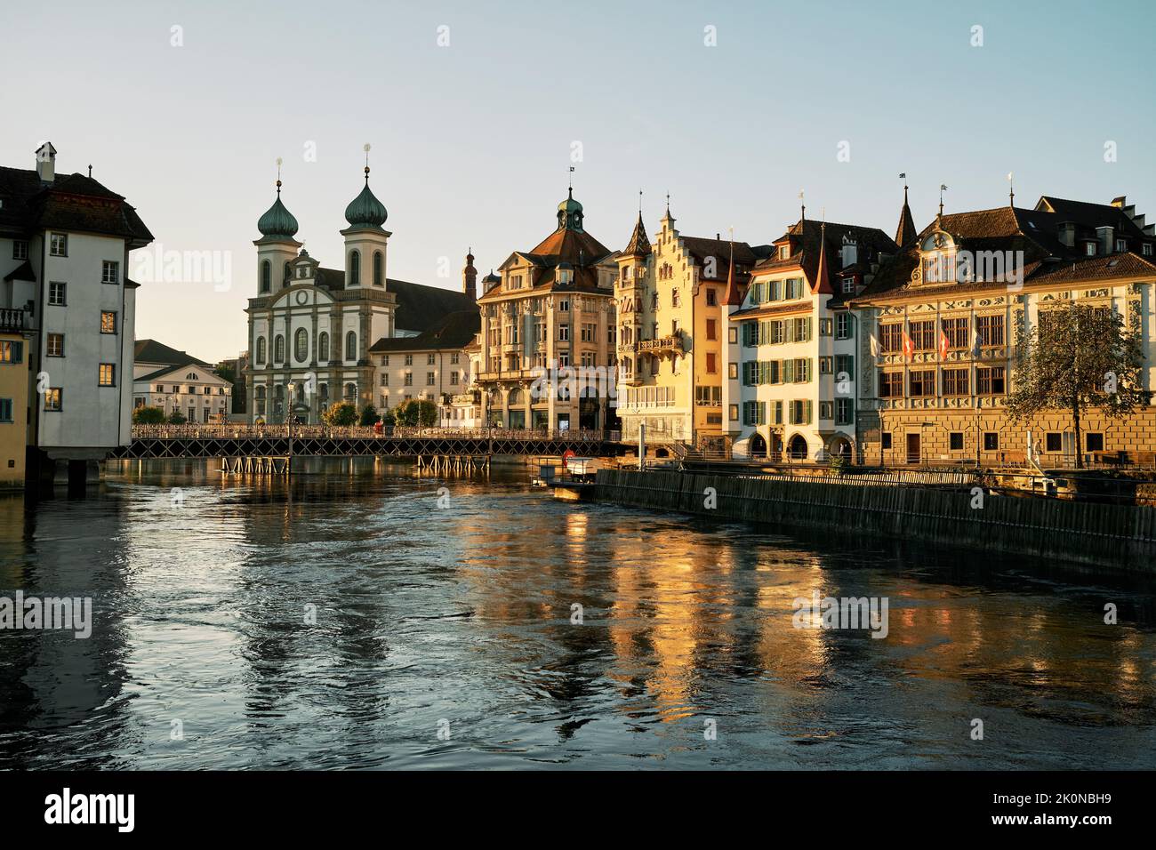 Footbridge over river in city old district near historic buildings ...