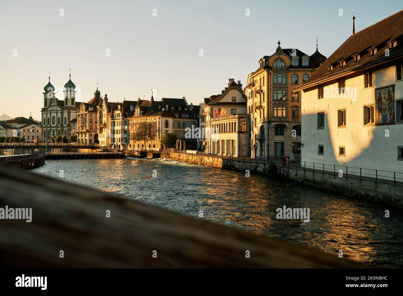 Exteriors of old buildings and Catholic church near river in old town ...